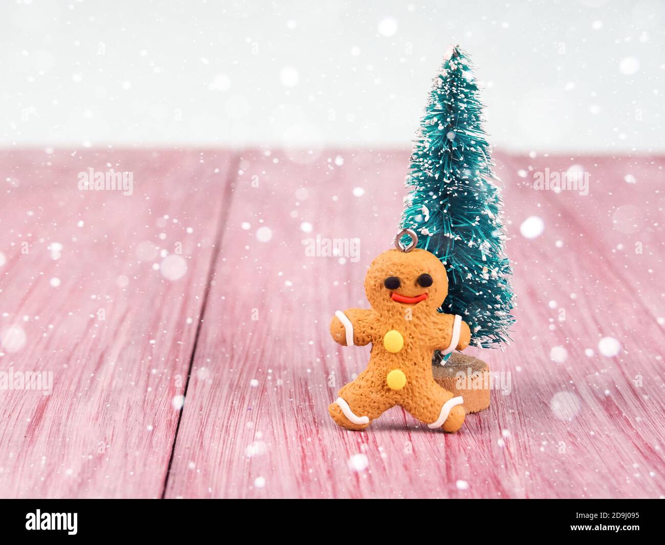 Gingerbread man and a small Christmas tree. traditional Christmas ...