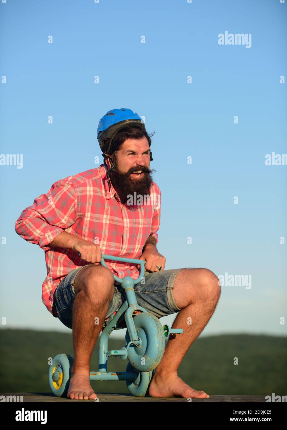 Nerdy hipster guy riding a small bicycle. Funny rider. Comic man ride ...