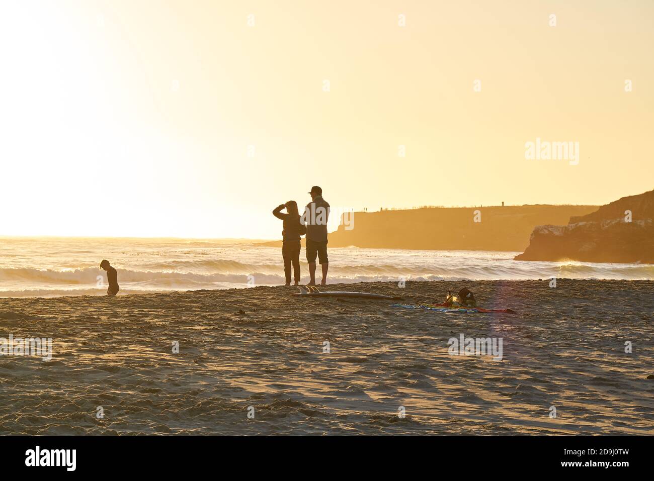 People enjoying sunset at a sandy beach on the Pacific Ocean in ...