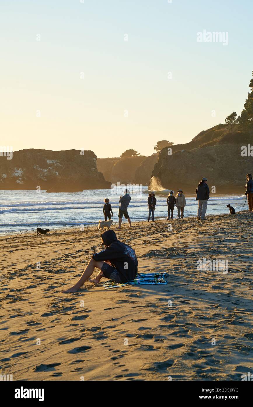 People enjoying sunset at a sandy beach on the Pacific Ocean in ...