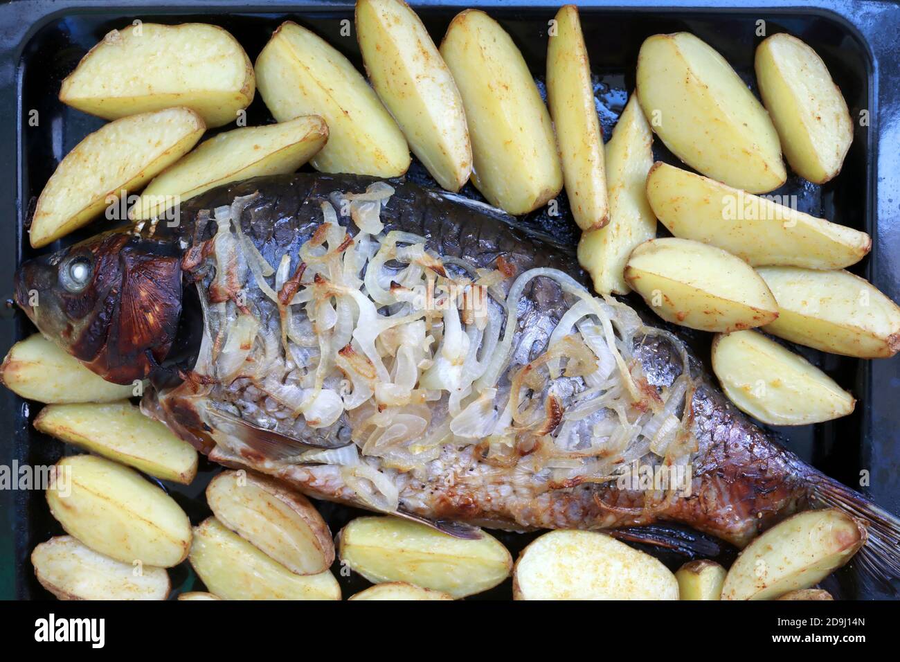 Baked carp with vegetables on baking sheet Stock Photo - Alamy