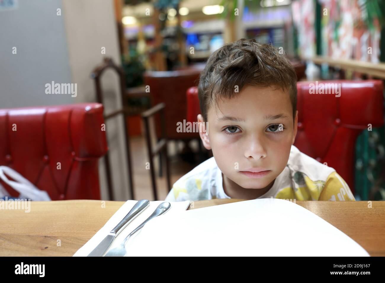 Portrait of pensive kid in a restaurant Stock Photo - Alamy