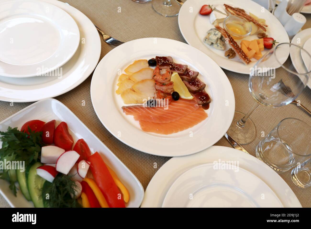 Dining table with various appetizers in restaurant Stock Photo - Alamy