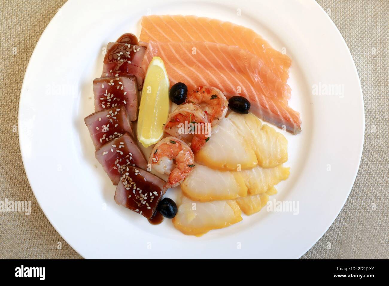 Slices various salted fish on plate in a restaurant Stock Photo - Alamy