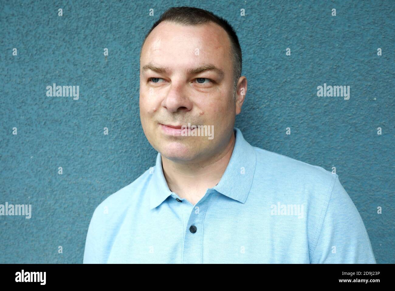 Portrait of man on cement wall background Stock Photo - Alamy