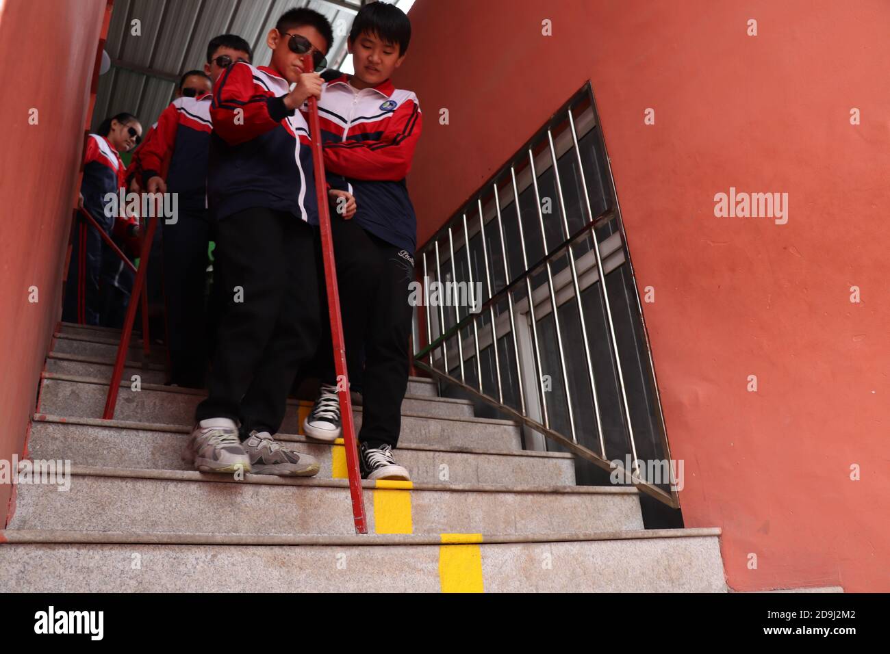 Primary students with blindfold on experience daily life of the blind ...