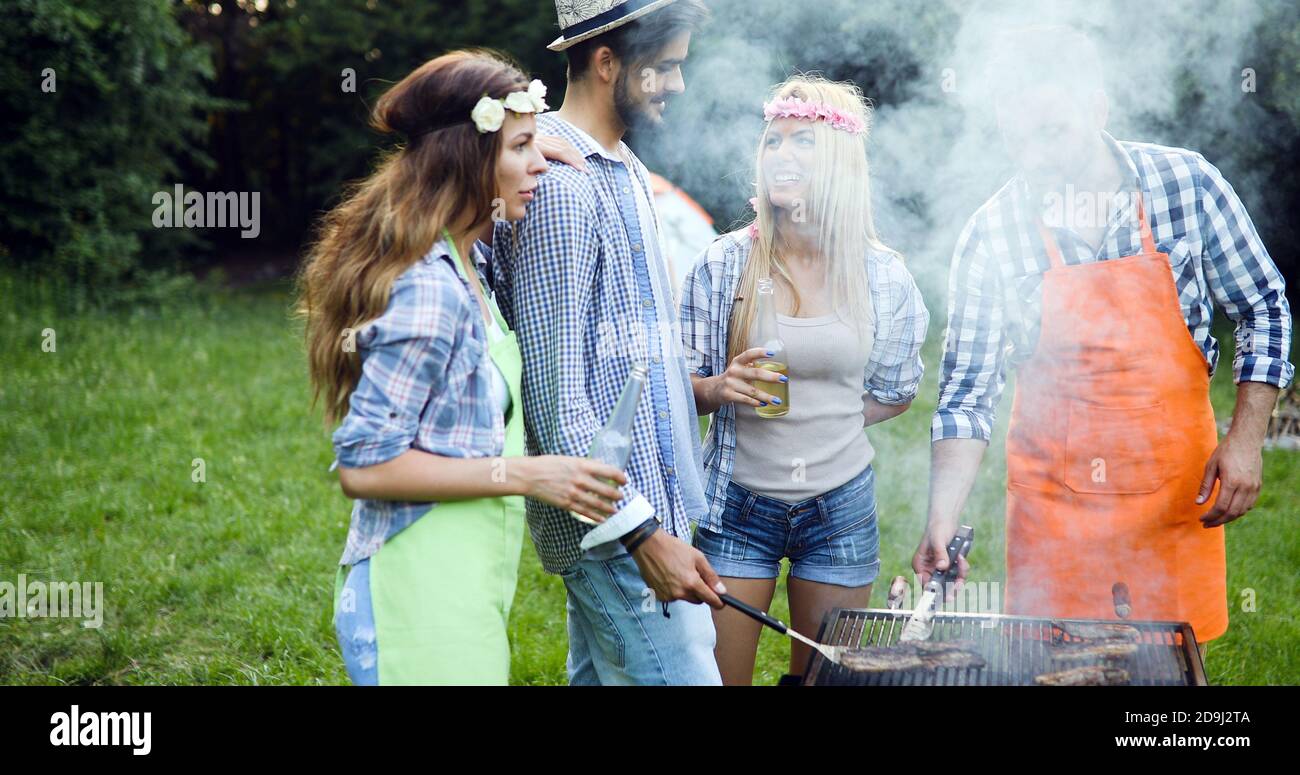 Happy friends enjoying barbecue party Stock Photo - Alamy