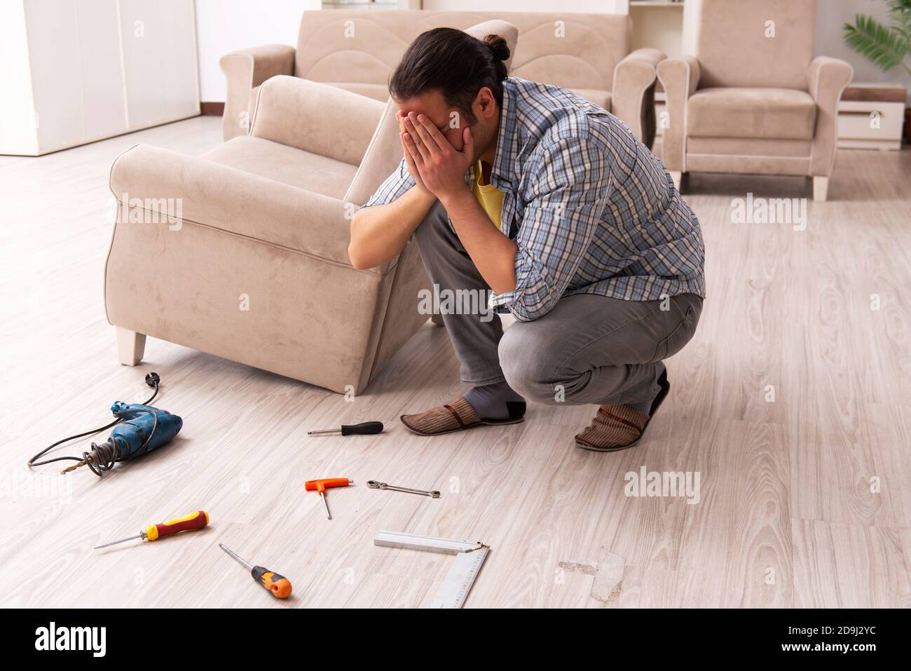 Young carpenter repairing furniture at home Stock Photo - Alamy