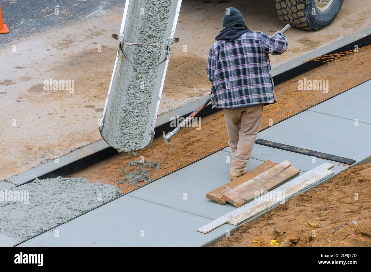 Construction mason worker leveling concrete with spreading poured ...