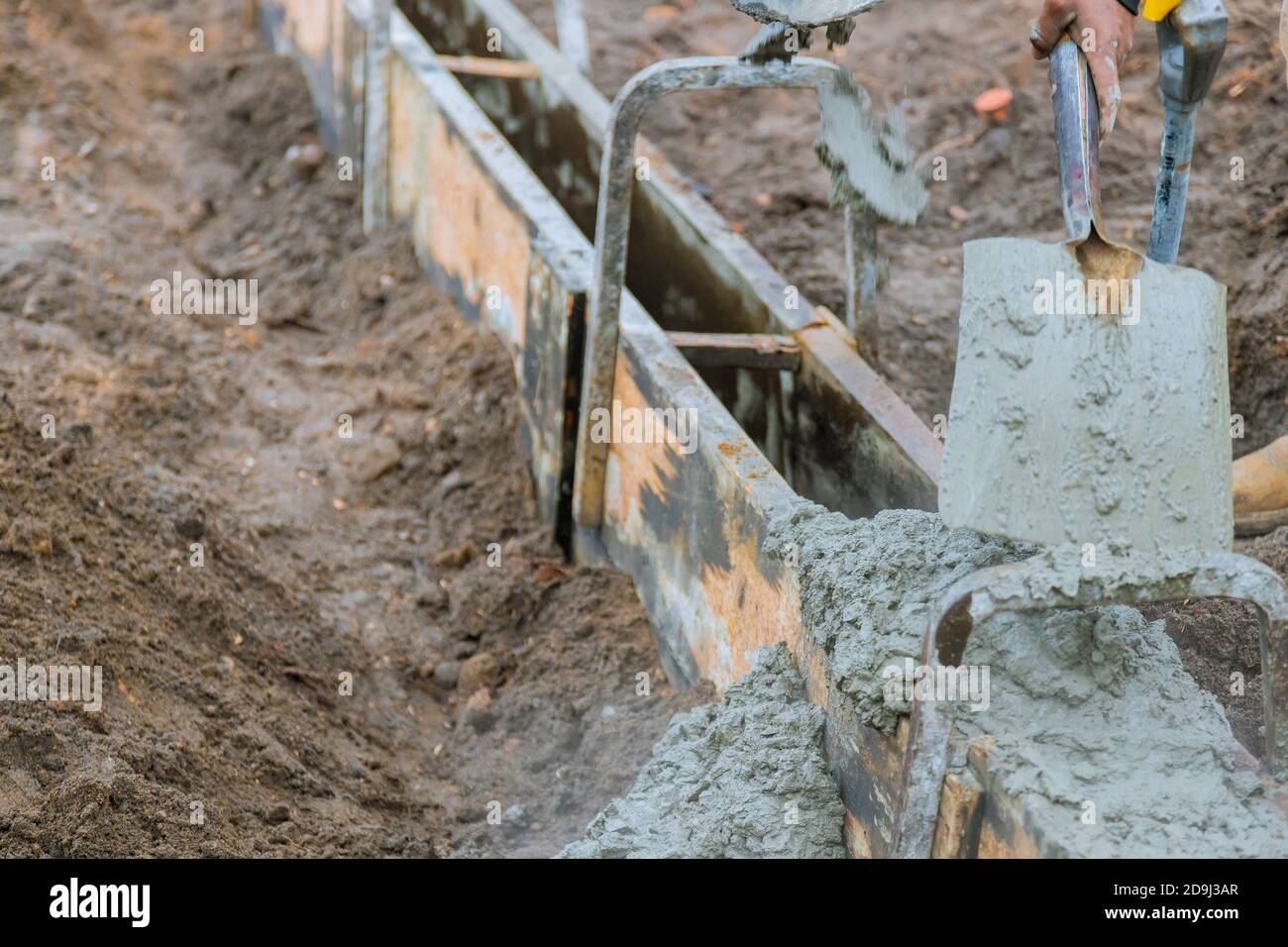 Concrete construction contractor installing a sidewalk, curb on a new ...