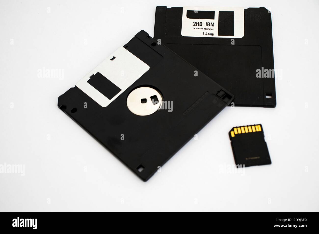 Old floppy disks and memory card on white background. Indoors Stock ...