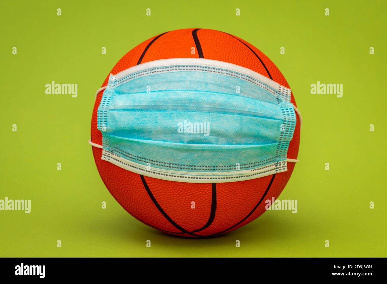 Basketball ball wearing surgical medical face mask. Concept for ...
