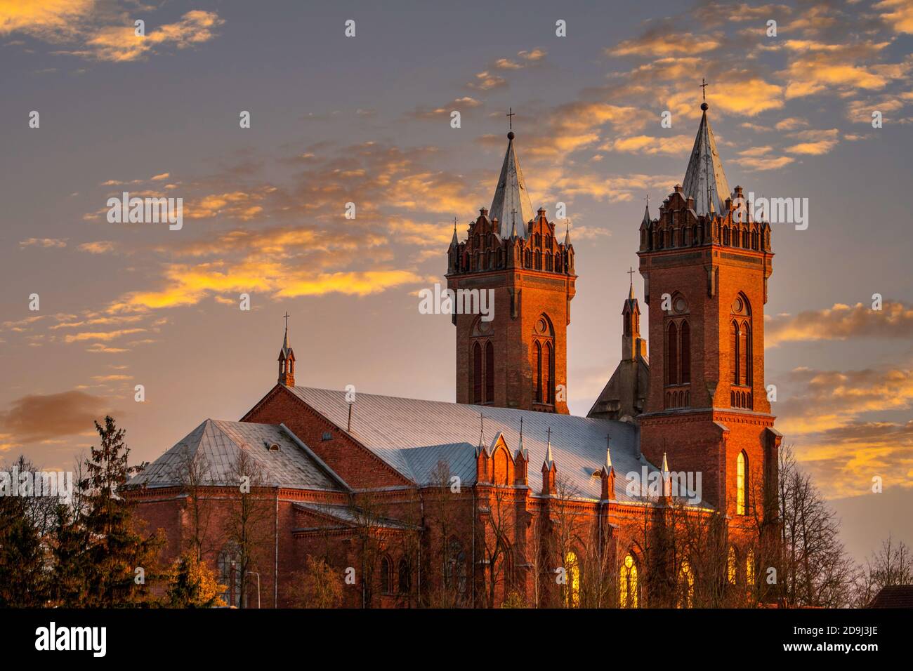 Scenic view of roofs of a tall church with bell towers on the sunset ...