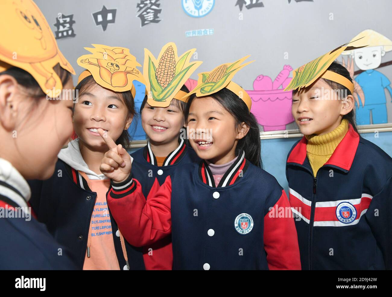 Kids make food-drawing hats in a school to welcome the World Food Day ...