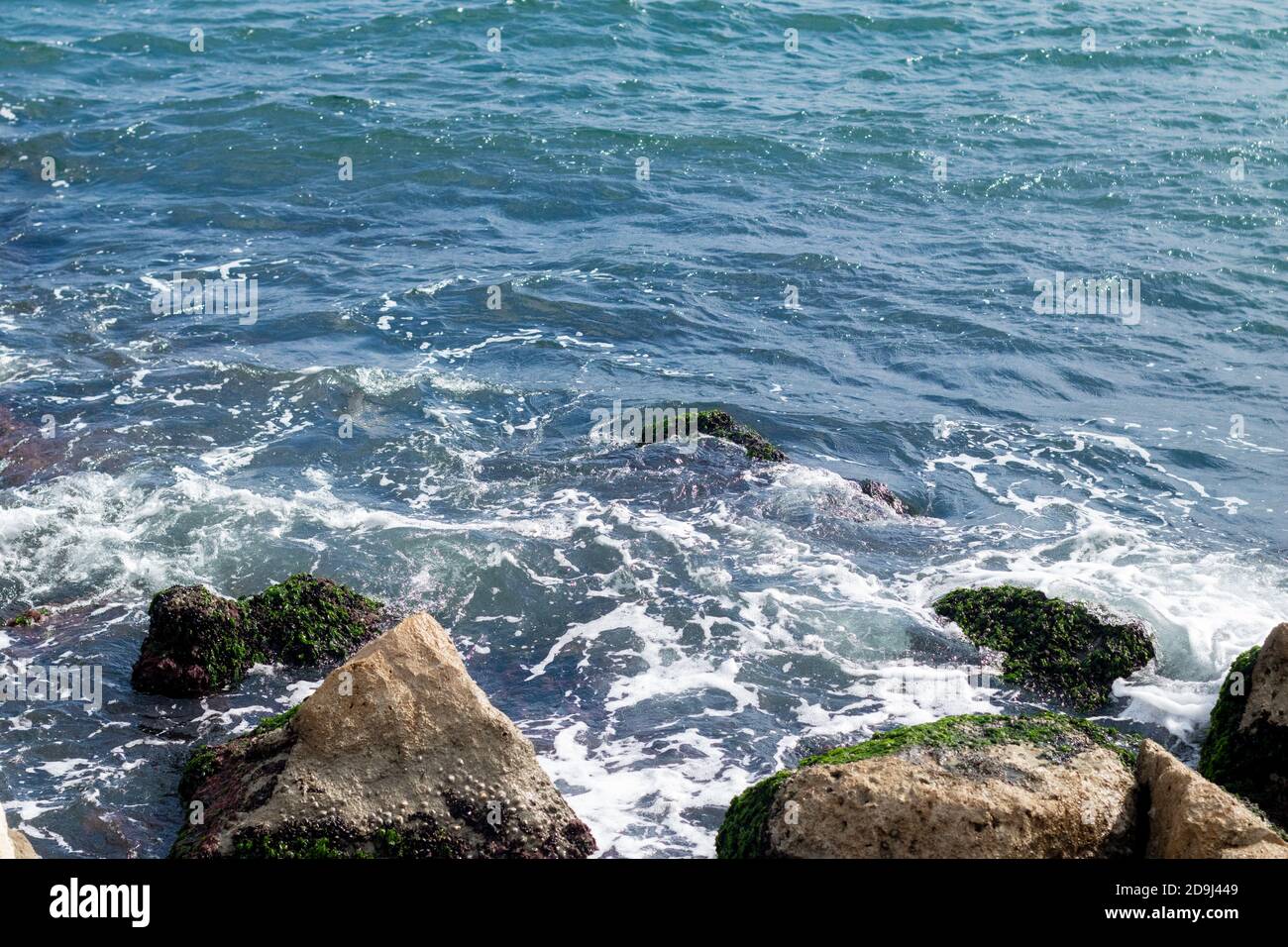 Ocean waves hiting and crash the stones. Turquoise sea water Stock ...