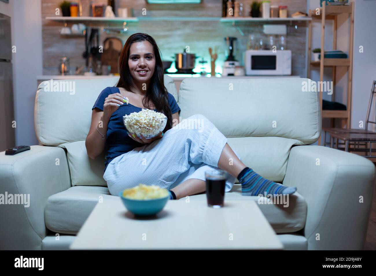 Woman alone watching comedy movie in tv hi-res stock photography and ...