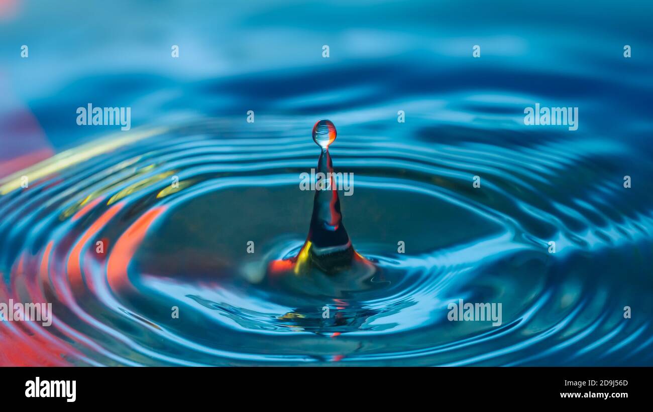 Blue Water drop splash with red tones Stock Photo - Alamy