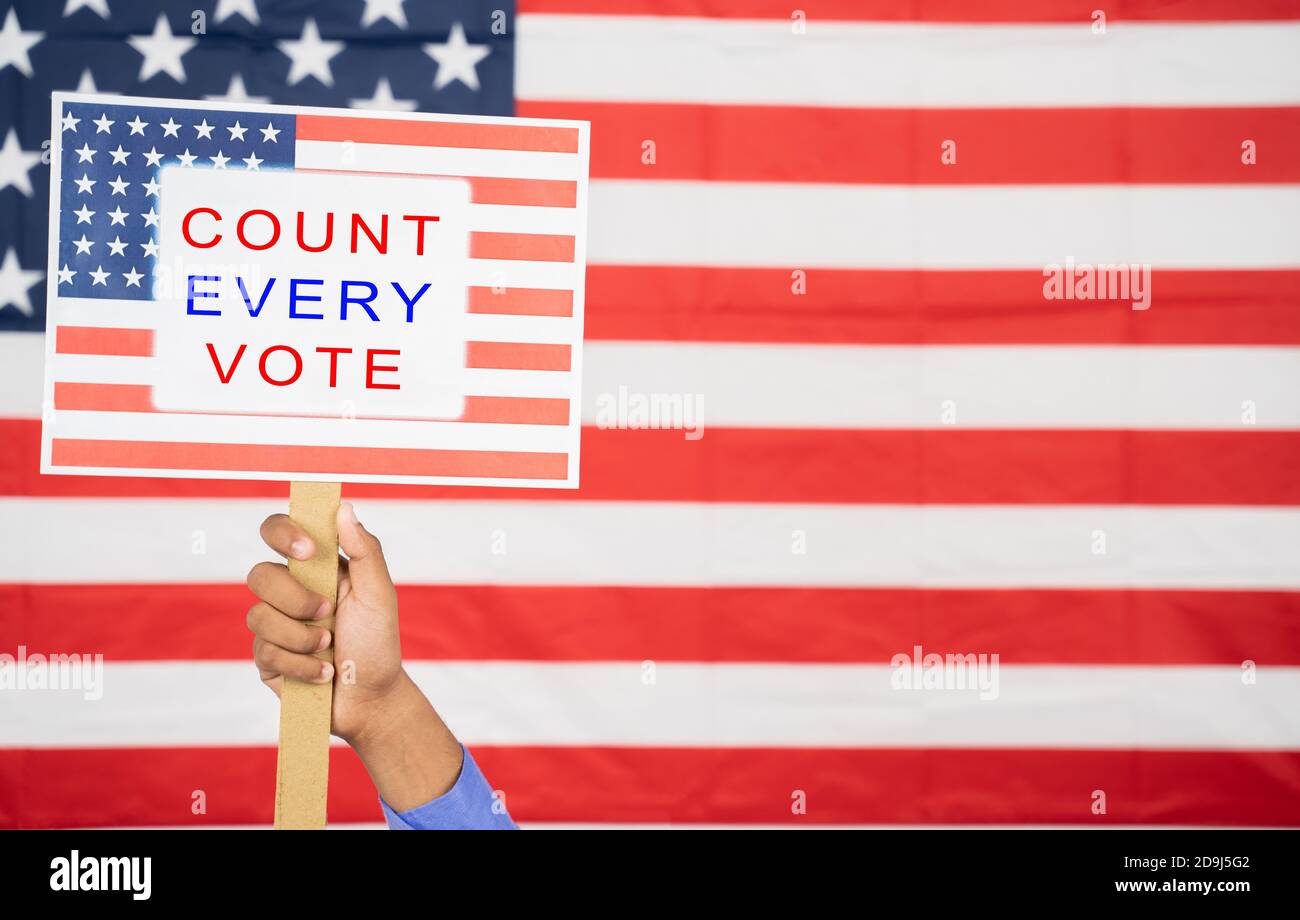 Hands Holding Count every vote sign board with US Flag as Background ...