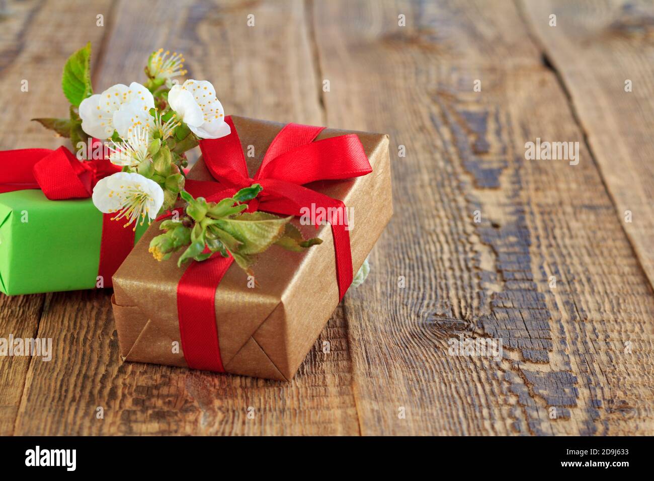 Gift boxes wrapped with red ribbons decorated with flowers of jasmine ...