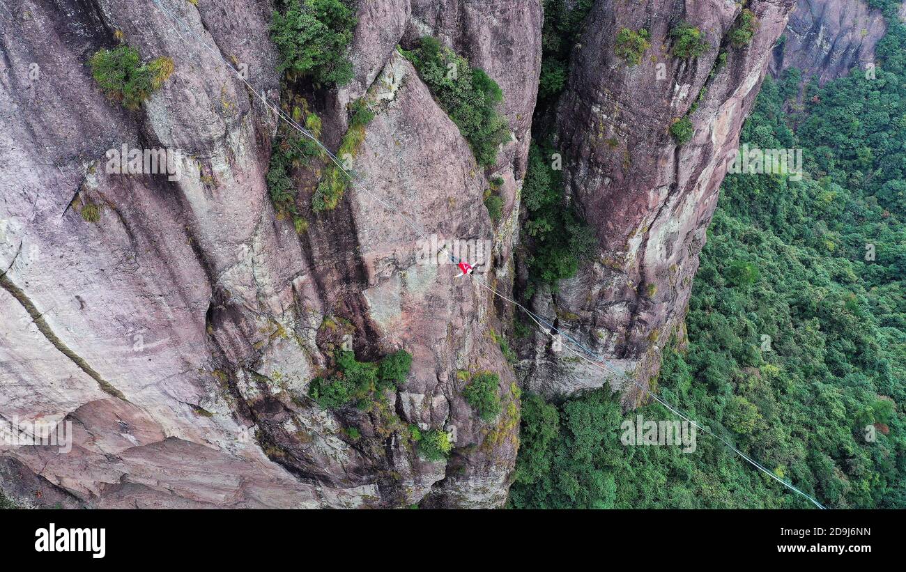 A slacking participant walks on a tight rope in the air at the 2020 ...