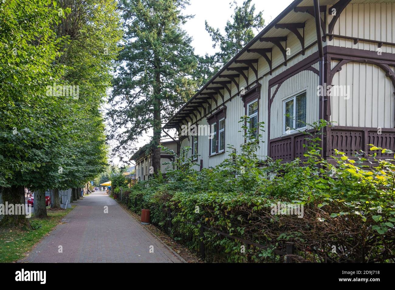 View of a quiet pedestrian street without people with a historic house ...