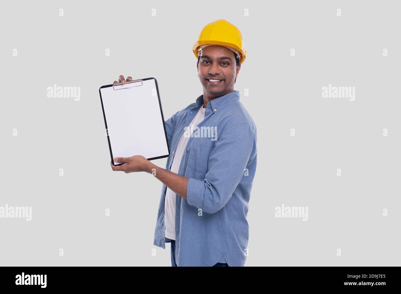 Construction Worker Showing Clipboard Wearing Yellow HardHat. Isolated ...