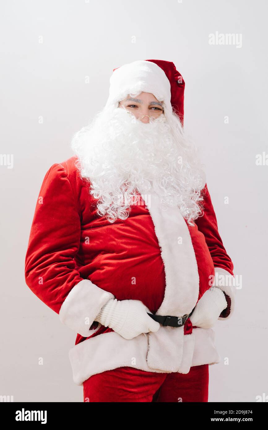 Pot-bellied Santa Claus, held by his hands for a belt Stock Photo - Alamy