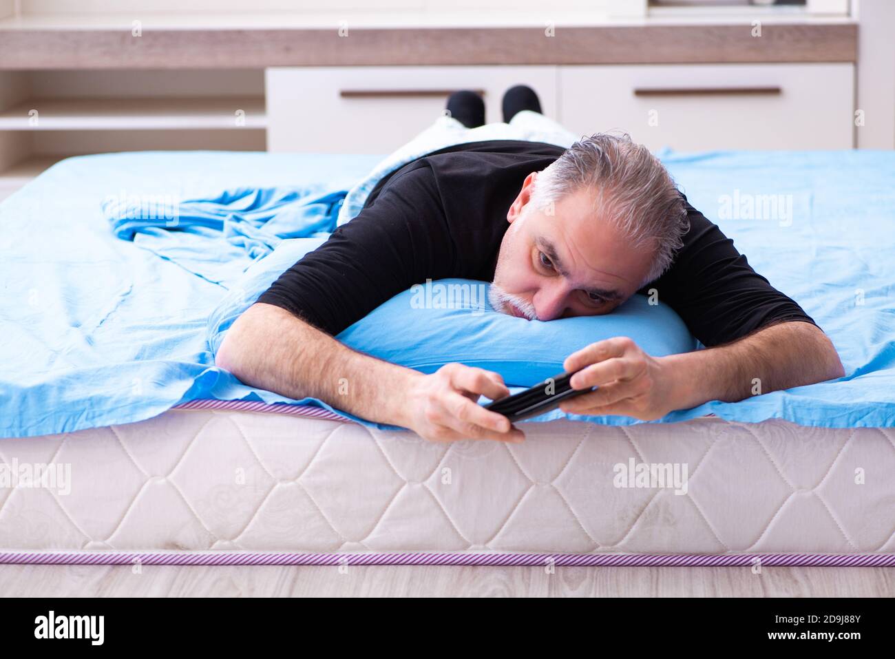 Old man in depression mode at home Stock Photo - Alamy
