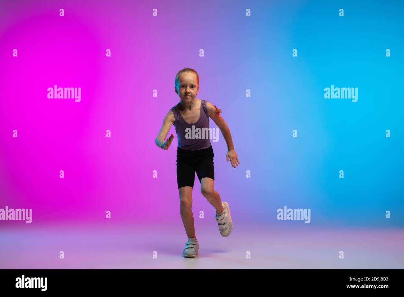 Playful. Teenage girl, professional runner, jogger in action, motion ...