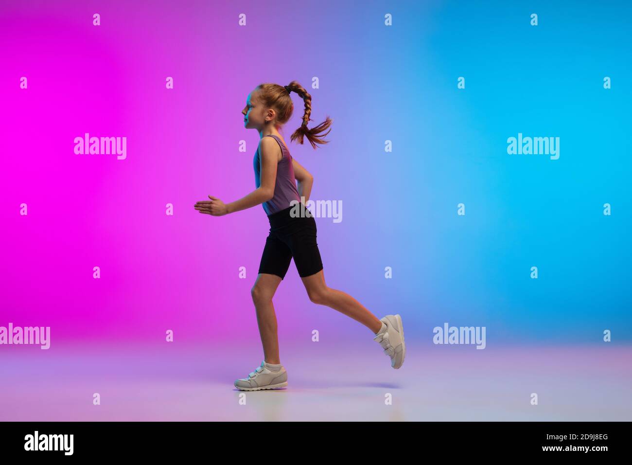 Profile. Teenage girl, professional runner, jogger in action, motion ...