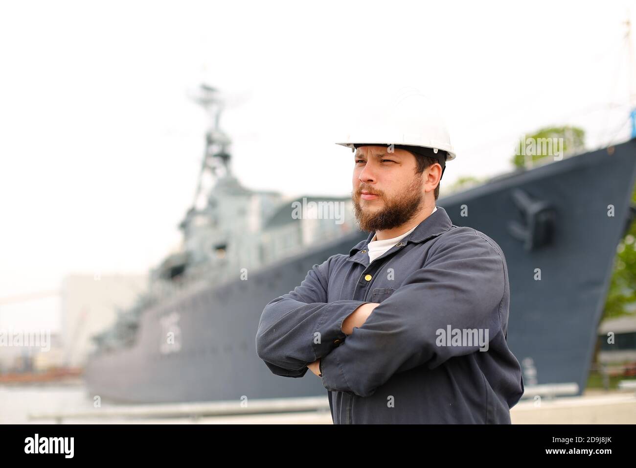 Portrait of chief officer standing near big vessel in background Stock ...