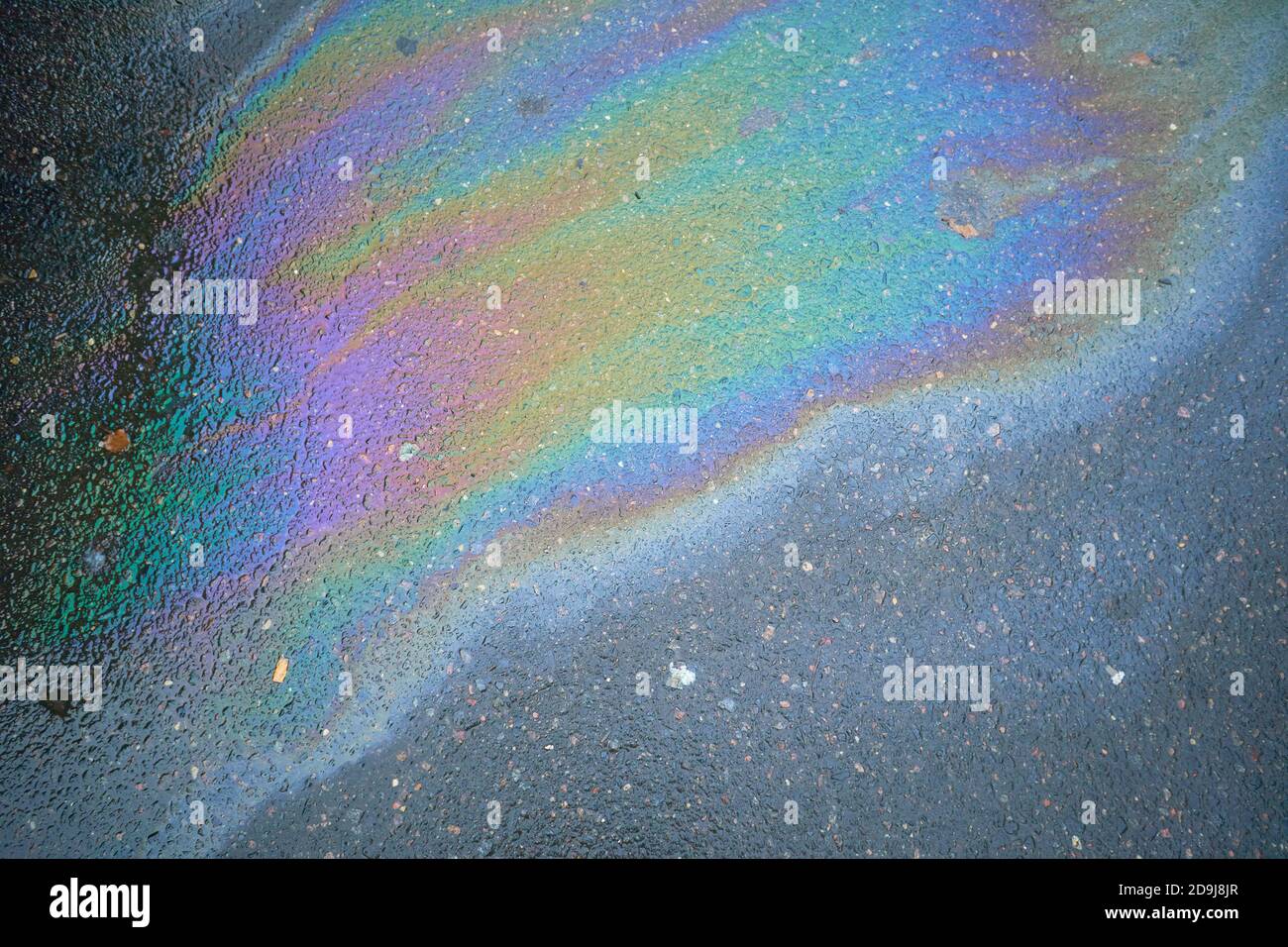 Abstract rainbow effect background, colorful gas stain on wet asphalt ...
