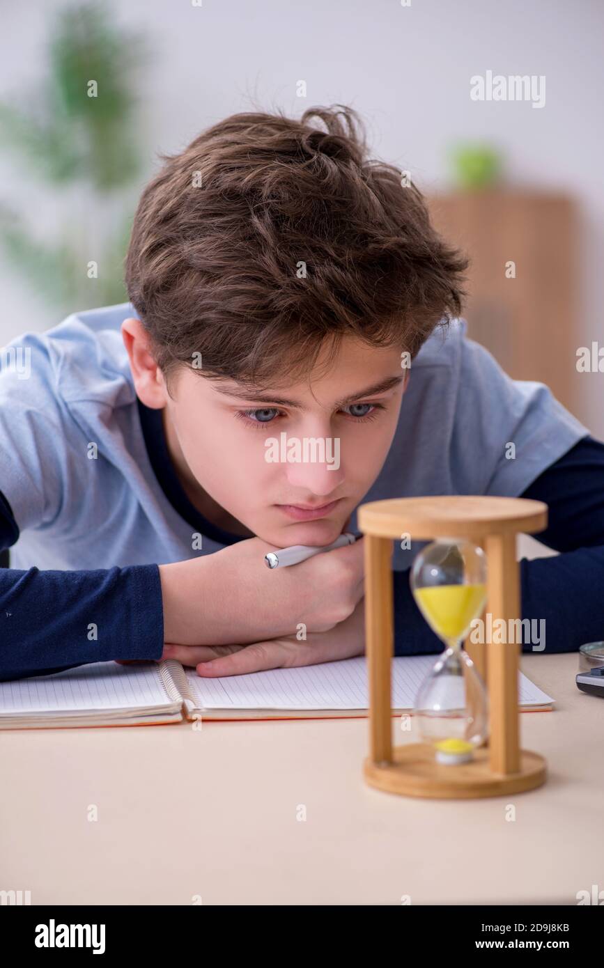 Boy preparing for exams in time management concept Stock Photo - Alamy
