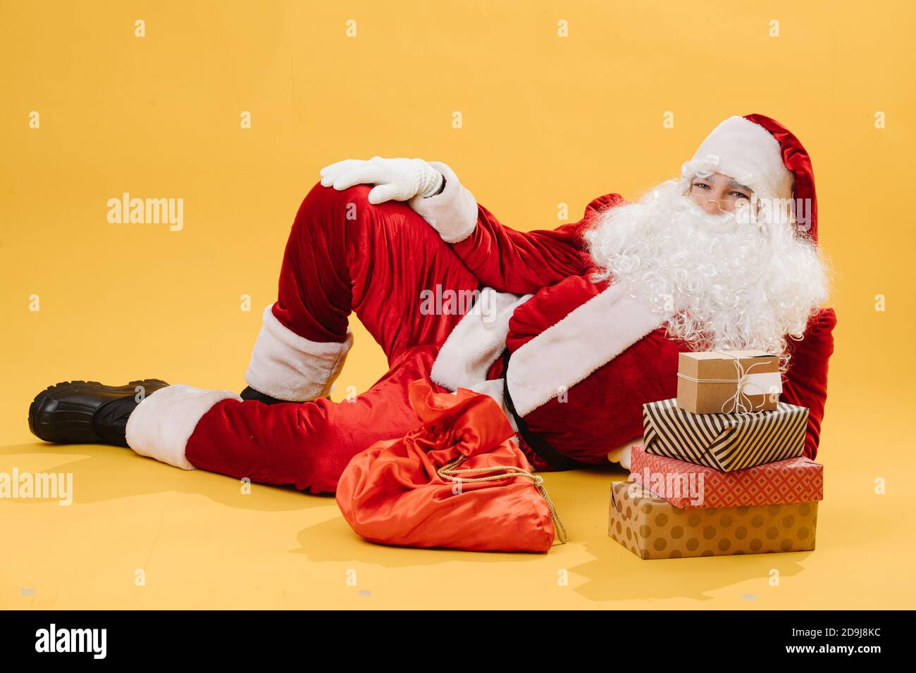 Cheerful Santa Claus lying in a funny pose, studio shot Stock Photo - Alamy