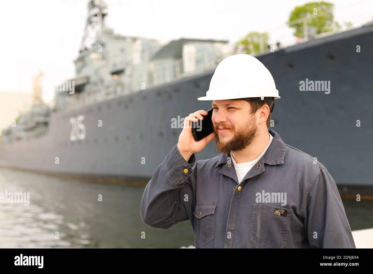 Marine deck officer talking by VHF walkie talkie near vessel in ...
