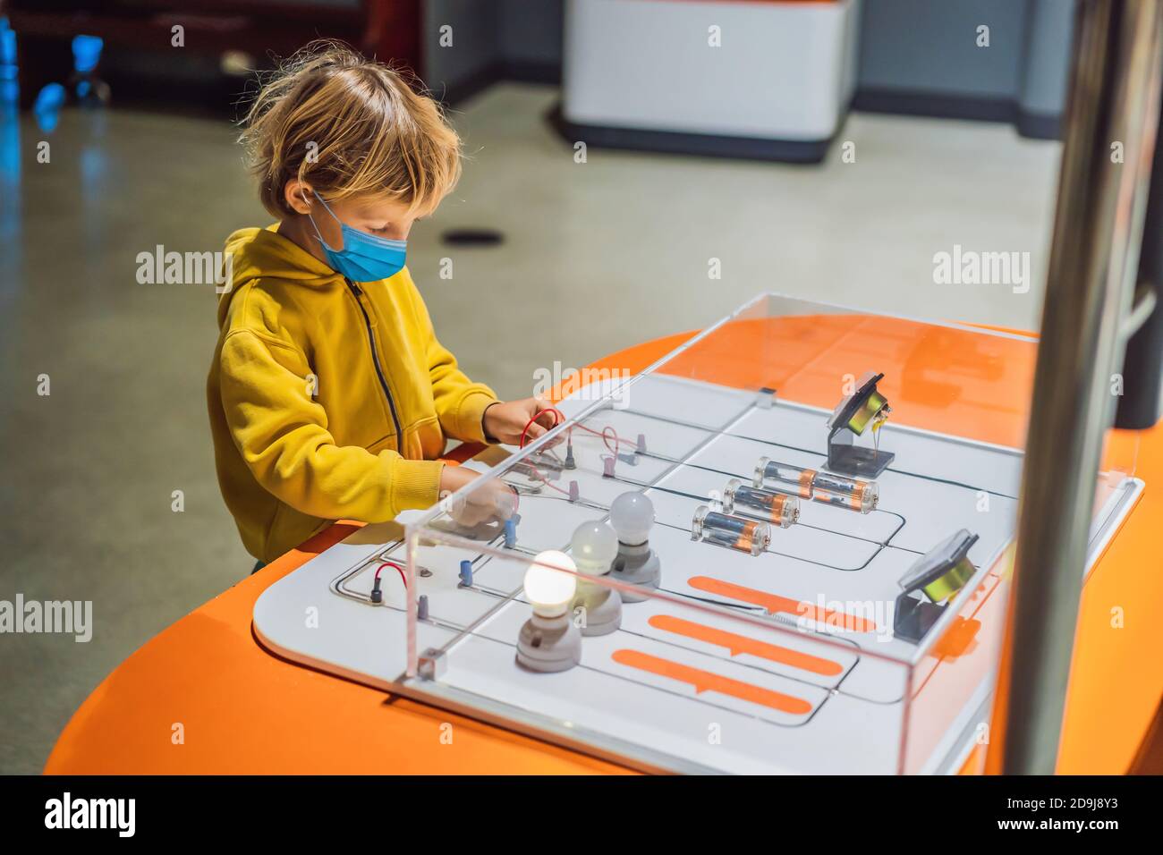 Boy in science class wearing a medical mask during COVID-19 coronavirus ...