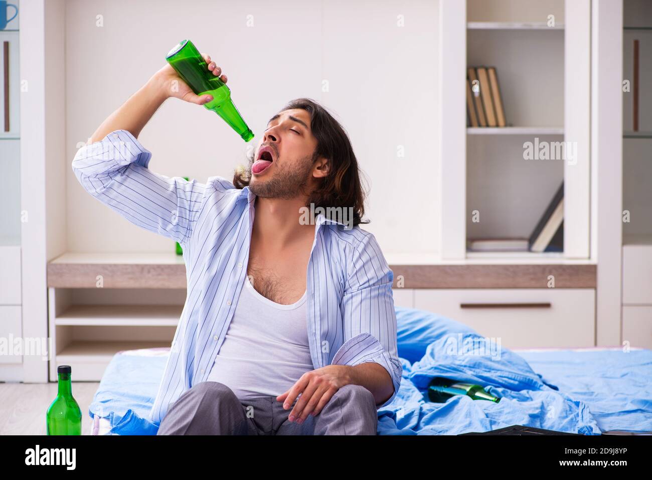 Male alcoholic in the bedroom Stock Photo - Alamy