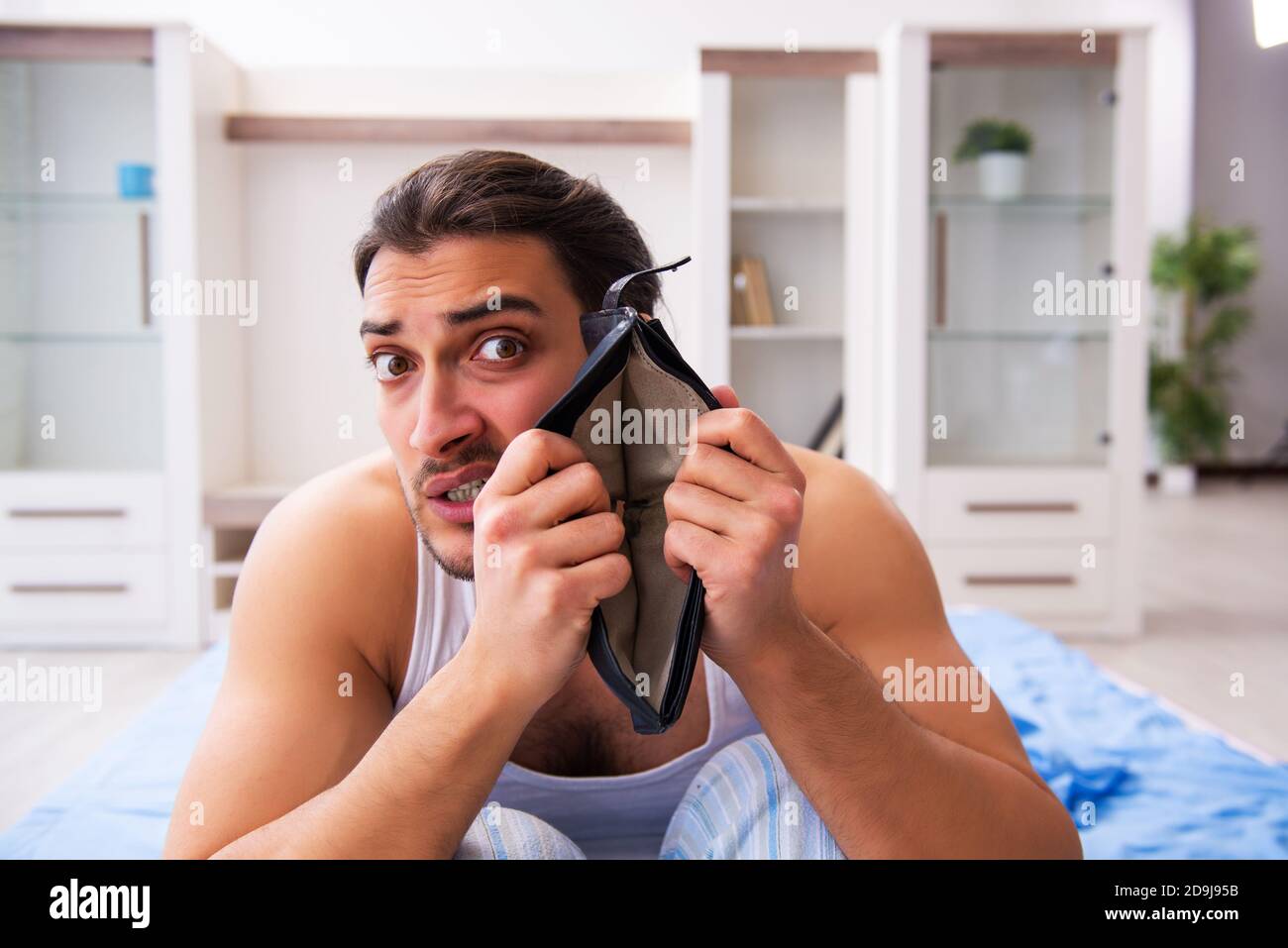 Young man in insolvency concept Stock Photo - Alamy