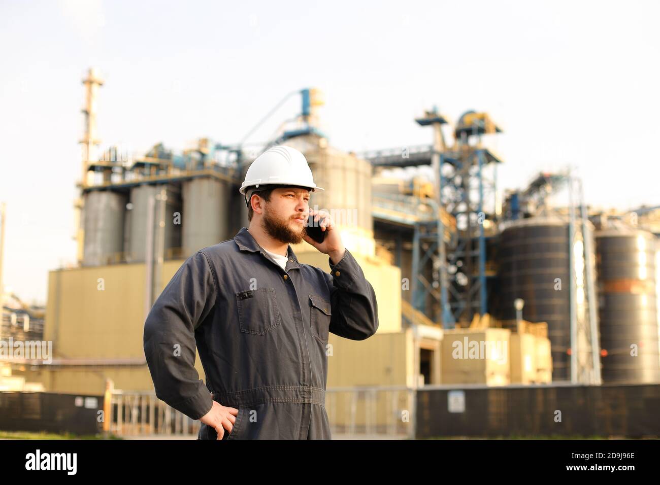 Industrial worker talking by VHF walkie talkie near factory outside ...