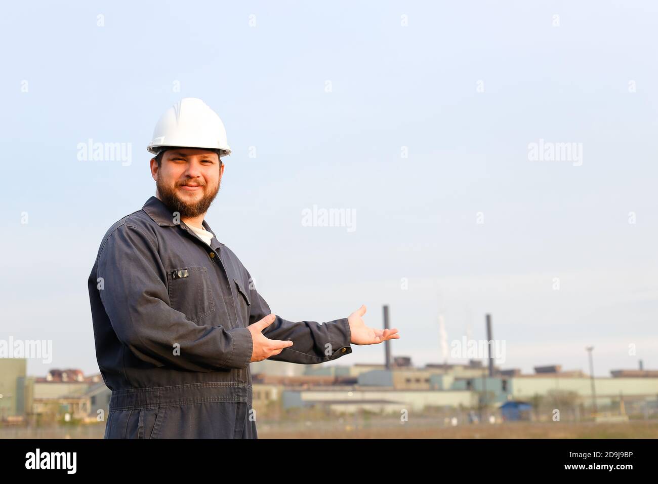 Portrait of male engineer in helmet standing in construction site ...