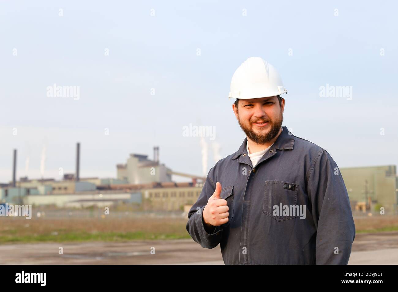 Portrait of caucasian foreman with thumbs up standing in construction ...