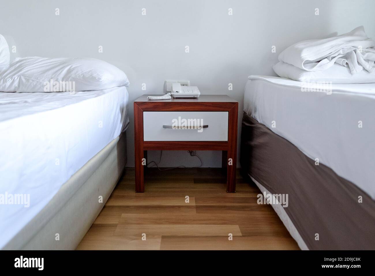 Bedside table with phone between two beds in the hotel Stock Photo - Alamy