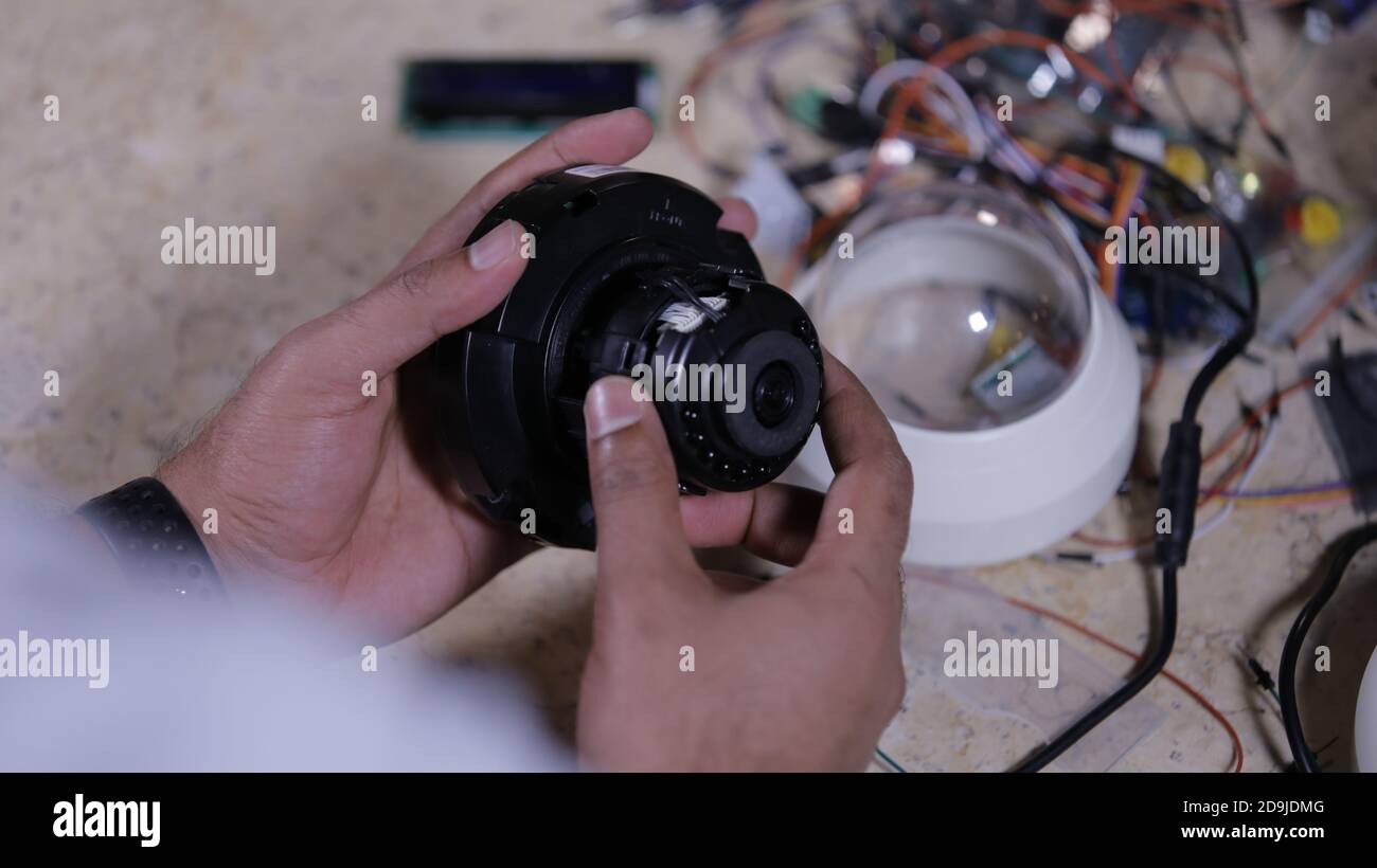 A man repairing CCTV camera in service centre Stock Photo - Alamy