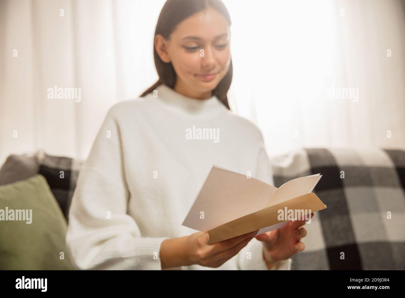 Woman opening, recieving greeting card for New Year and Christmas 2021 ...