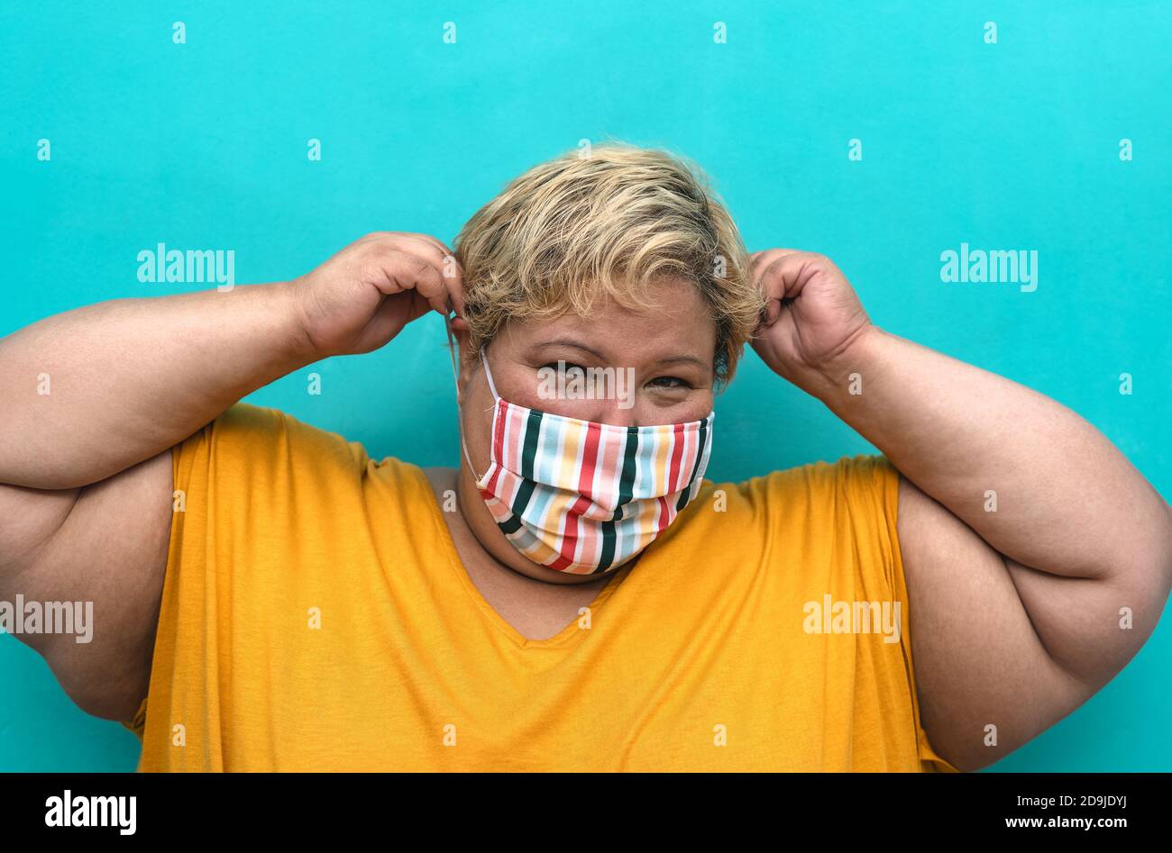 Happy plus size woman wearing face mask portrait - Curvy overweight ...