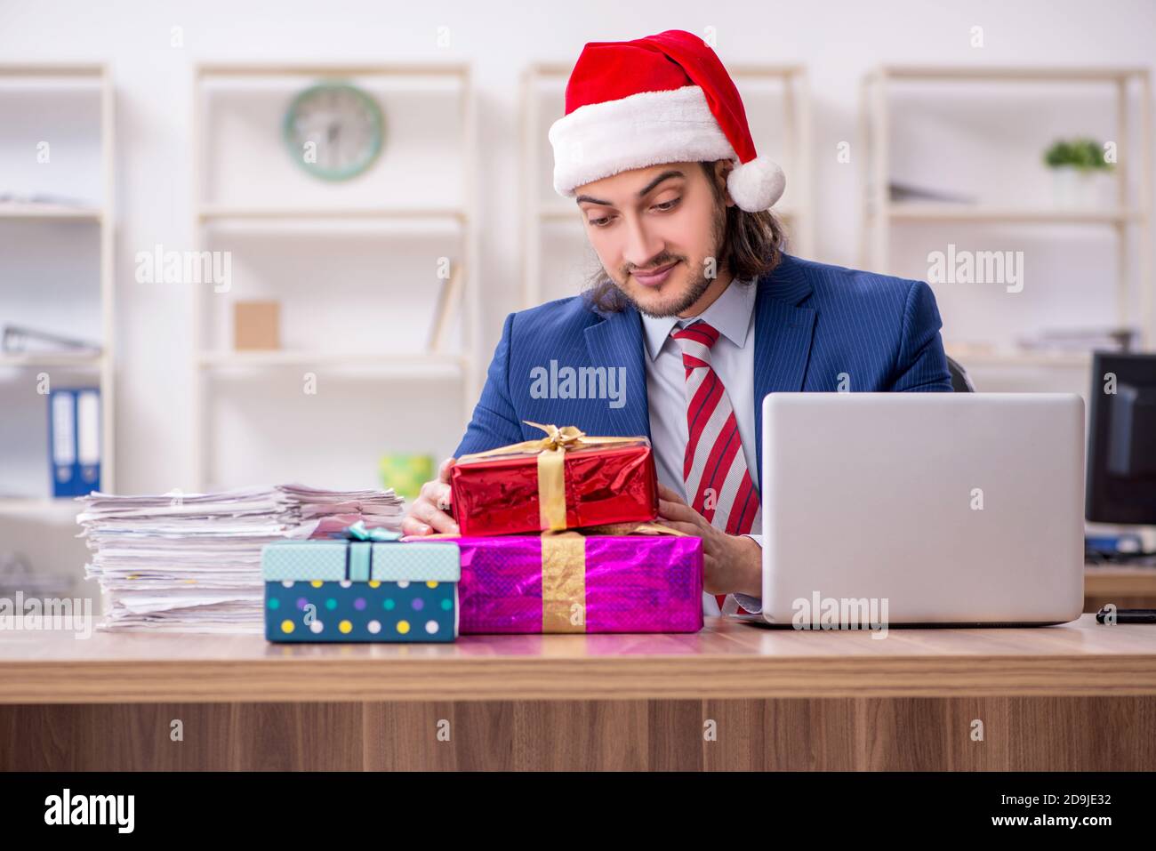 Young employee working in the office at Christmas Eve Stock Photo - Alamy