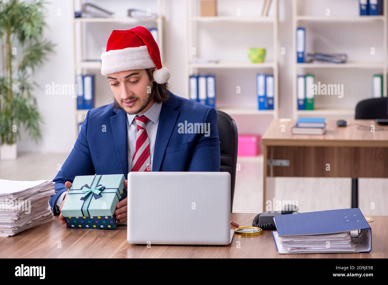 Young employee working in the office at Christmas Eve Stock Photo - Alamy