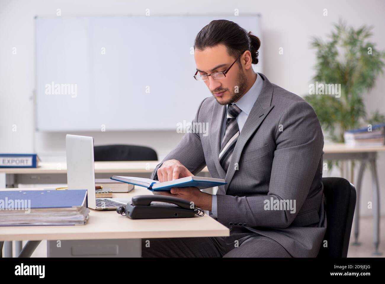 Male employee working in the office Stock Photo - Alamy