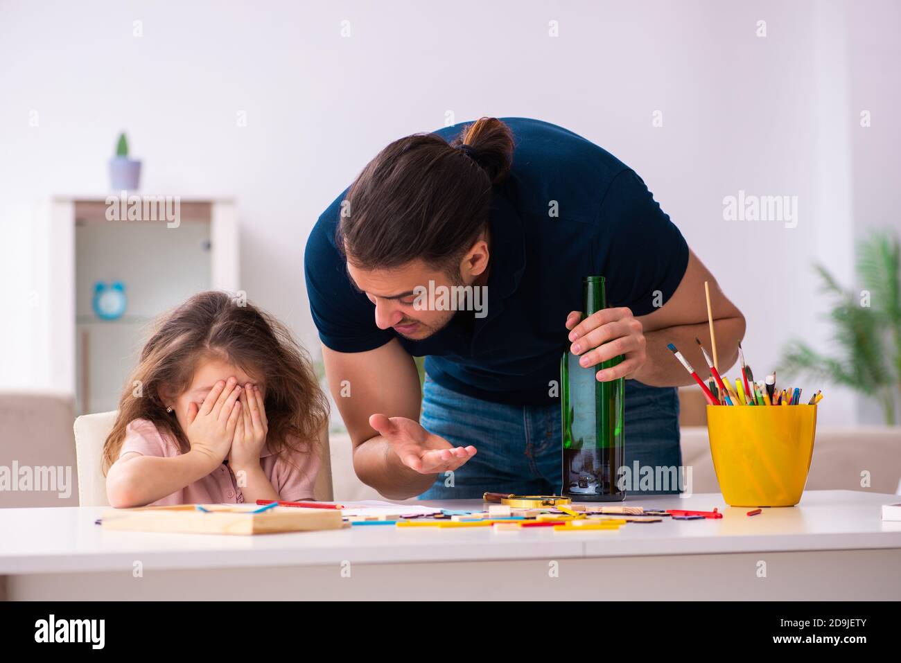 Drunk father and little girl at home Stock Photo - Alamy
