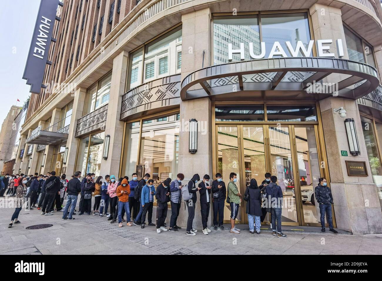 Customers queue at the flagship store of Huawei located on the east ...